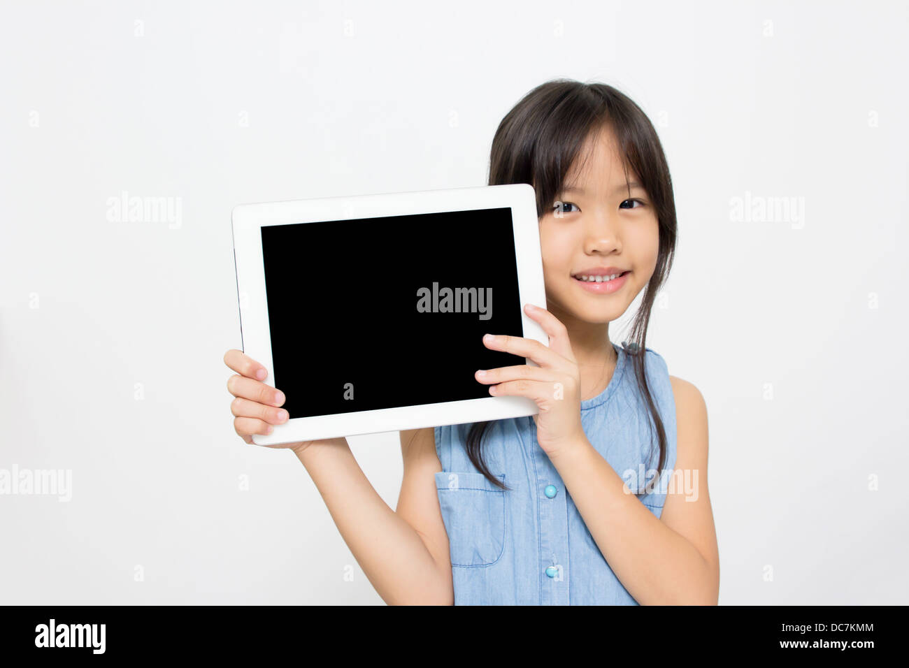 Happy Asian child with tablet computer Stock Photo - Alamy