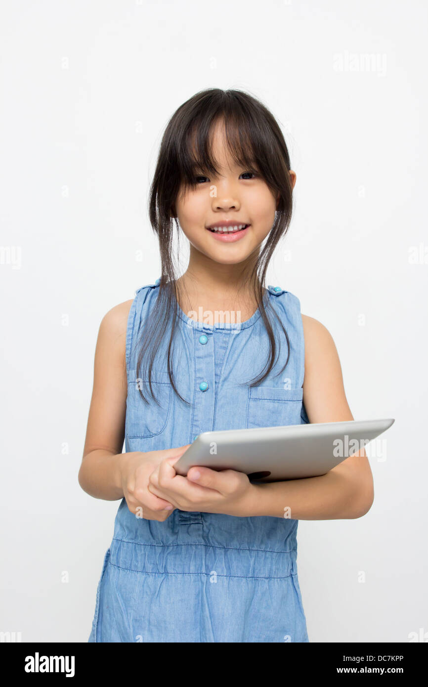 Happy Asian child with tablet computer Stock Photo - Alamy