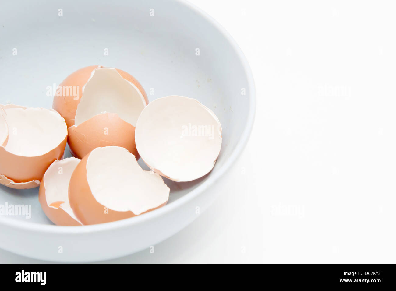 Heap of egg shell in a dirty bowl with white background Stock Photo - Alamy