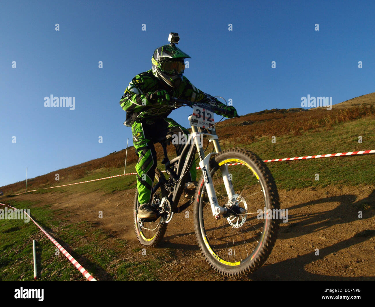 Mountain biker on dusty track Stock Photo - Alamy