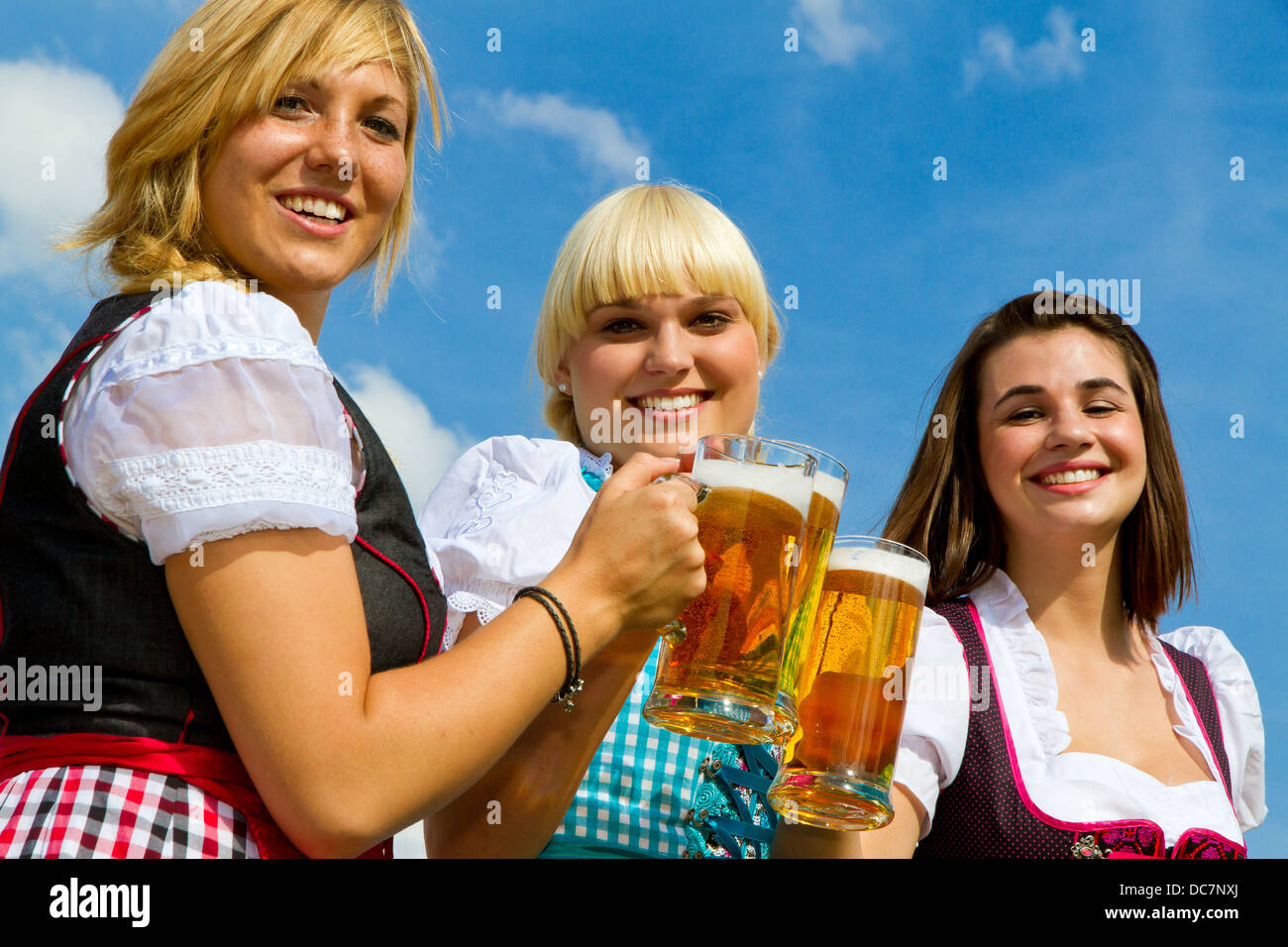 Three girls drinking beer Stock Photo - Alamy