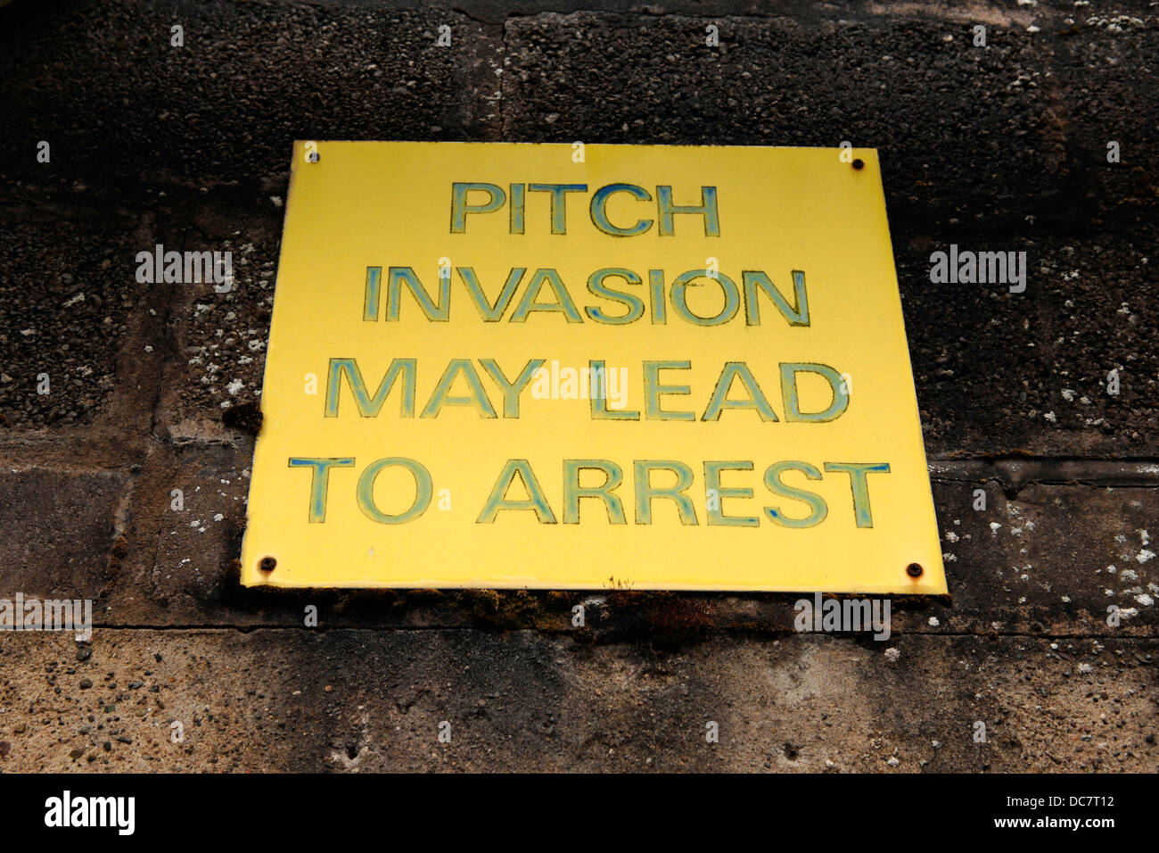pitch invasion may lead to arrest sign Stock Photo - Alamy