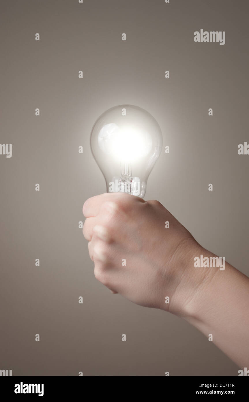 Hand with light bulb Stock Photo - Alamy