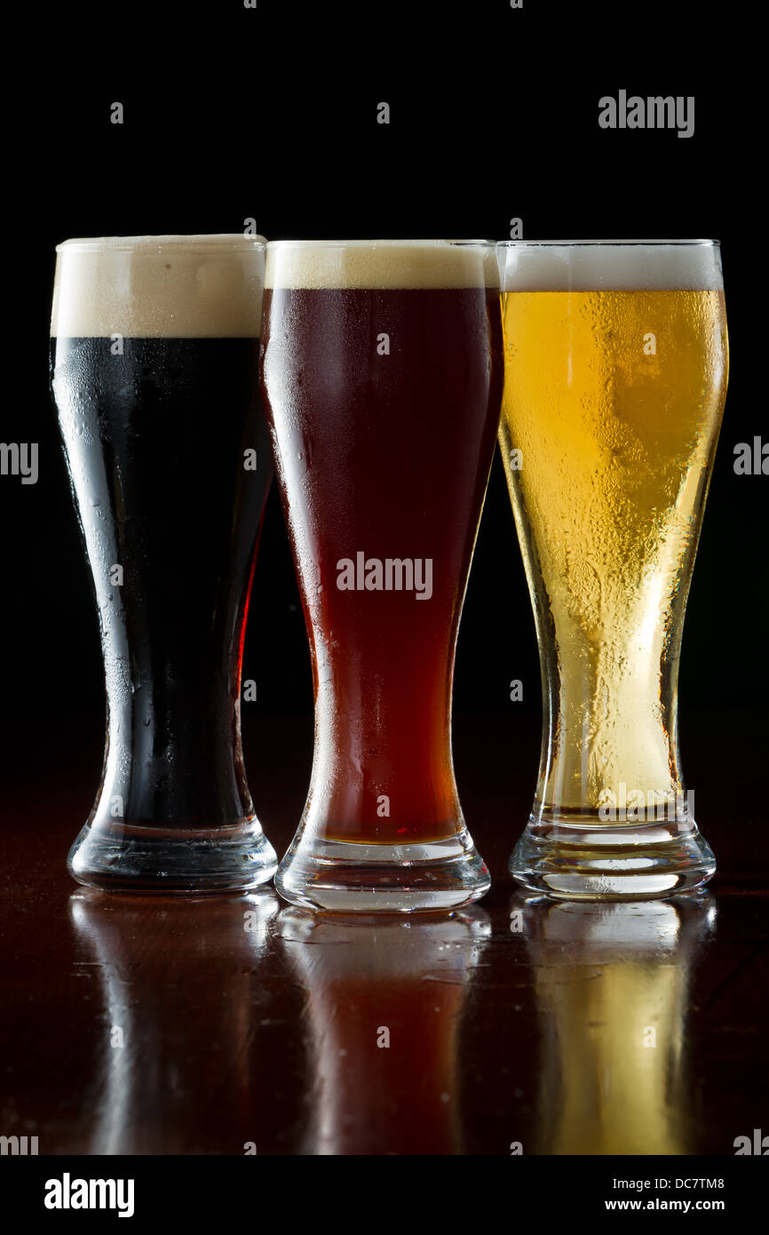 dark, red and light beer served on a dark bar Stock Photo - Alamy