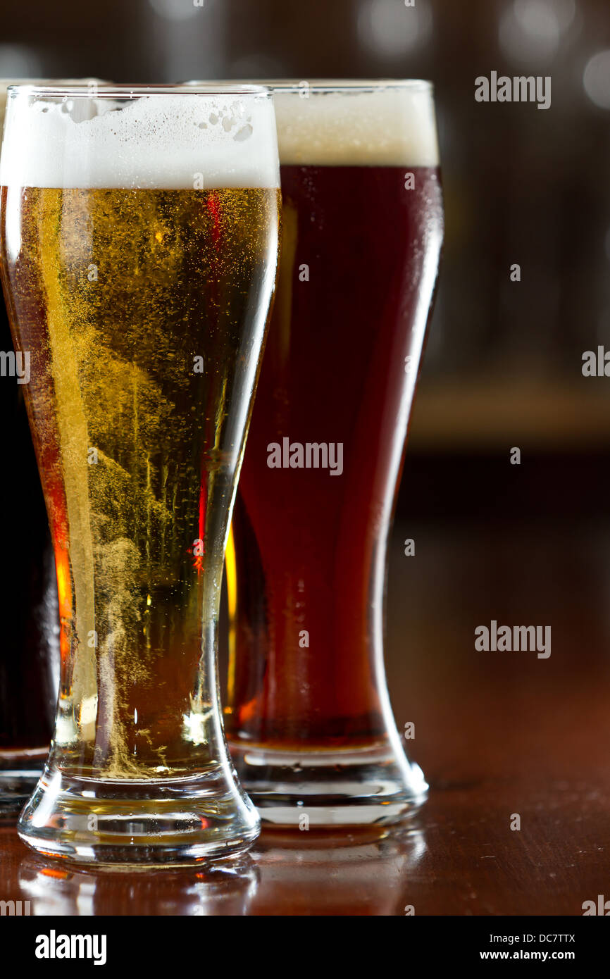 dark, red and light beer served on a dark bar Stock Photo - Alamy