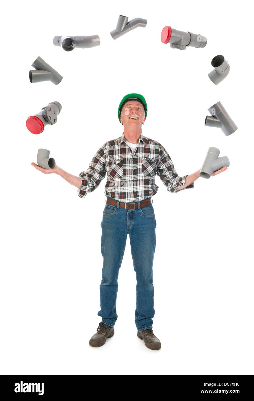 Funny plumber juggling with PVC tubes over white background Stock Photo ...