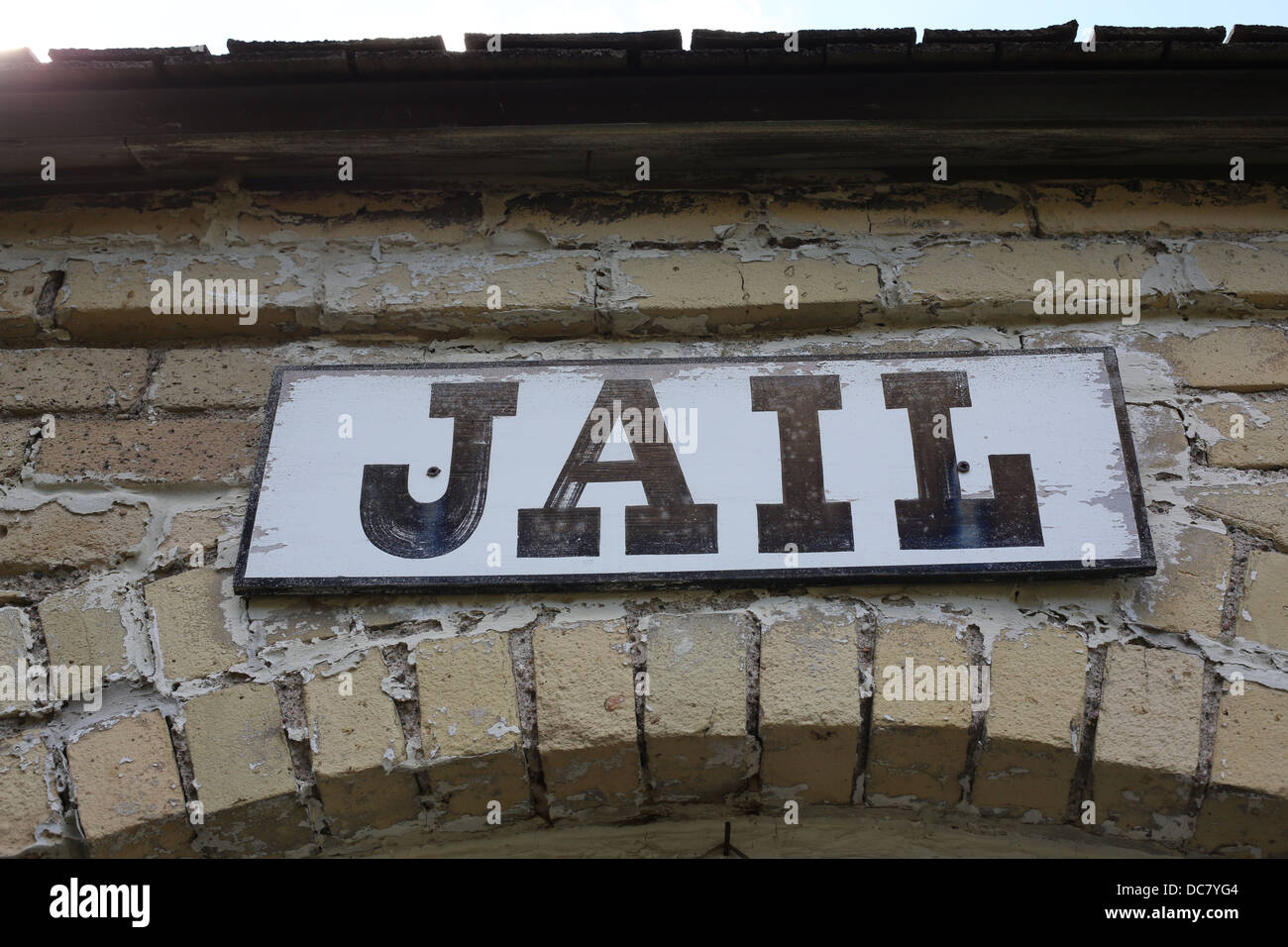 An old fashioned sign that reads "jail Stock Photo - Alamy