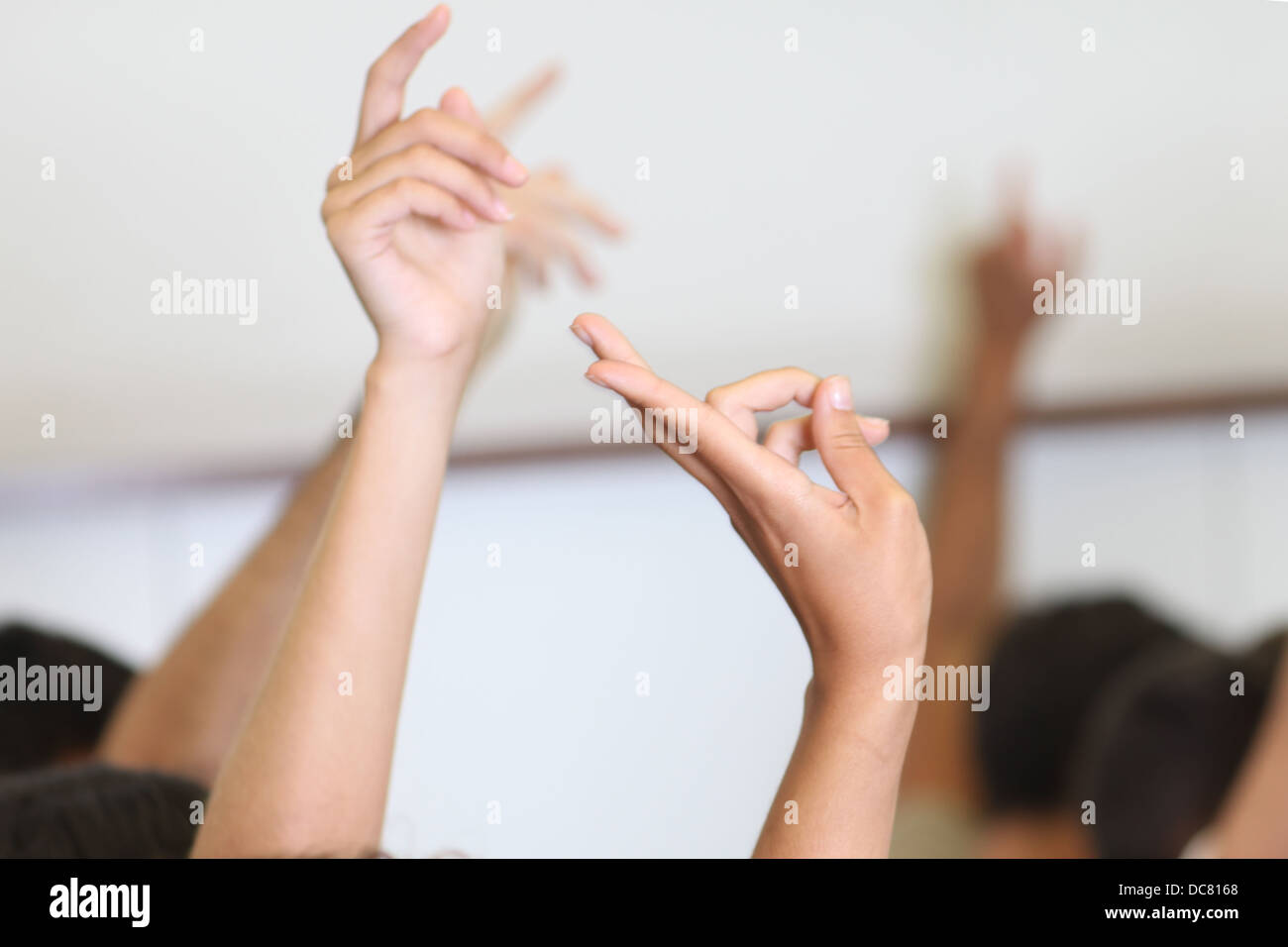 putting hands up Stock Photo - Alamy