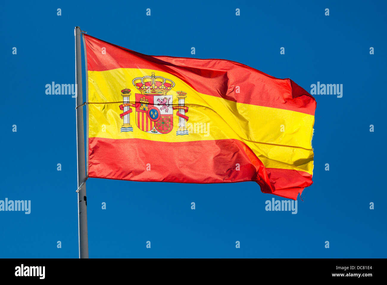 Spanish flag over clear blue sky Stock Photo - Alamy