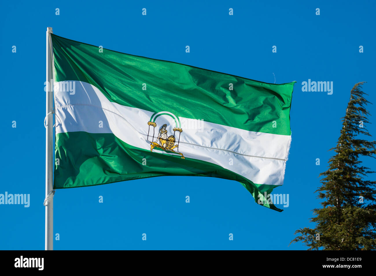 Flag of Andalusia over clear blue sky in Ronda, Spain Stock Photo - Alamy