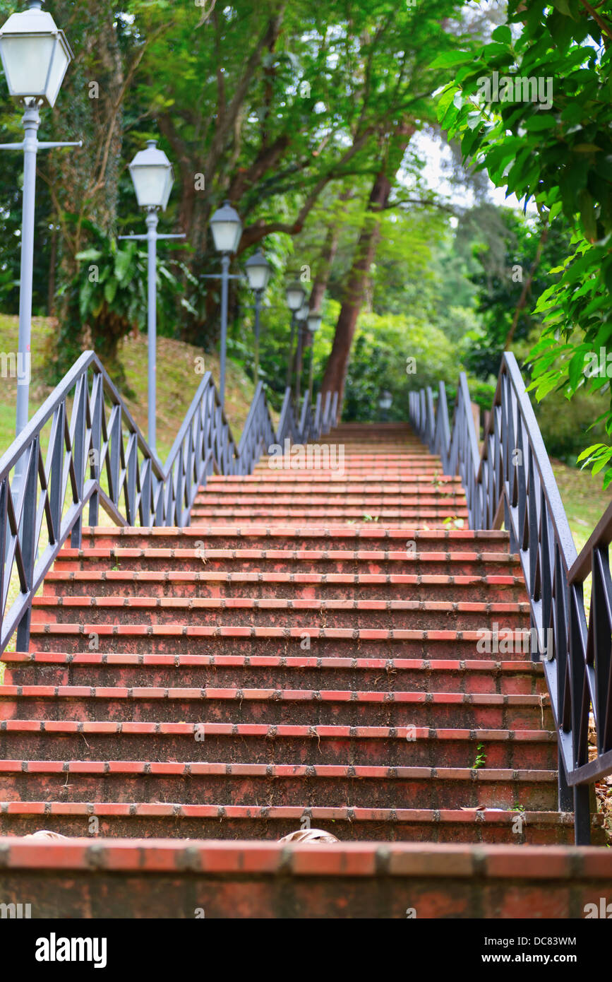Red stone stairs on in a park with handrail and street lamp Stock Photo ...