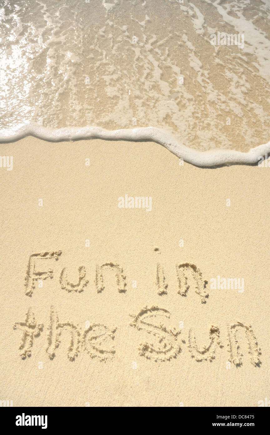 The Words 'Fun in the Sun' Written in the Sand on a Beach Stock Photo ...