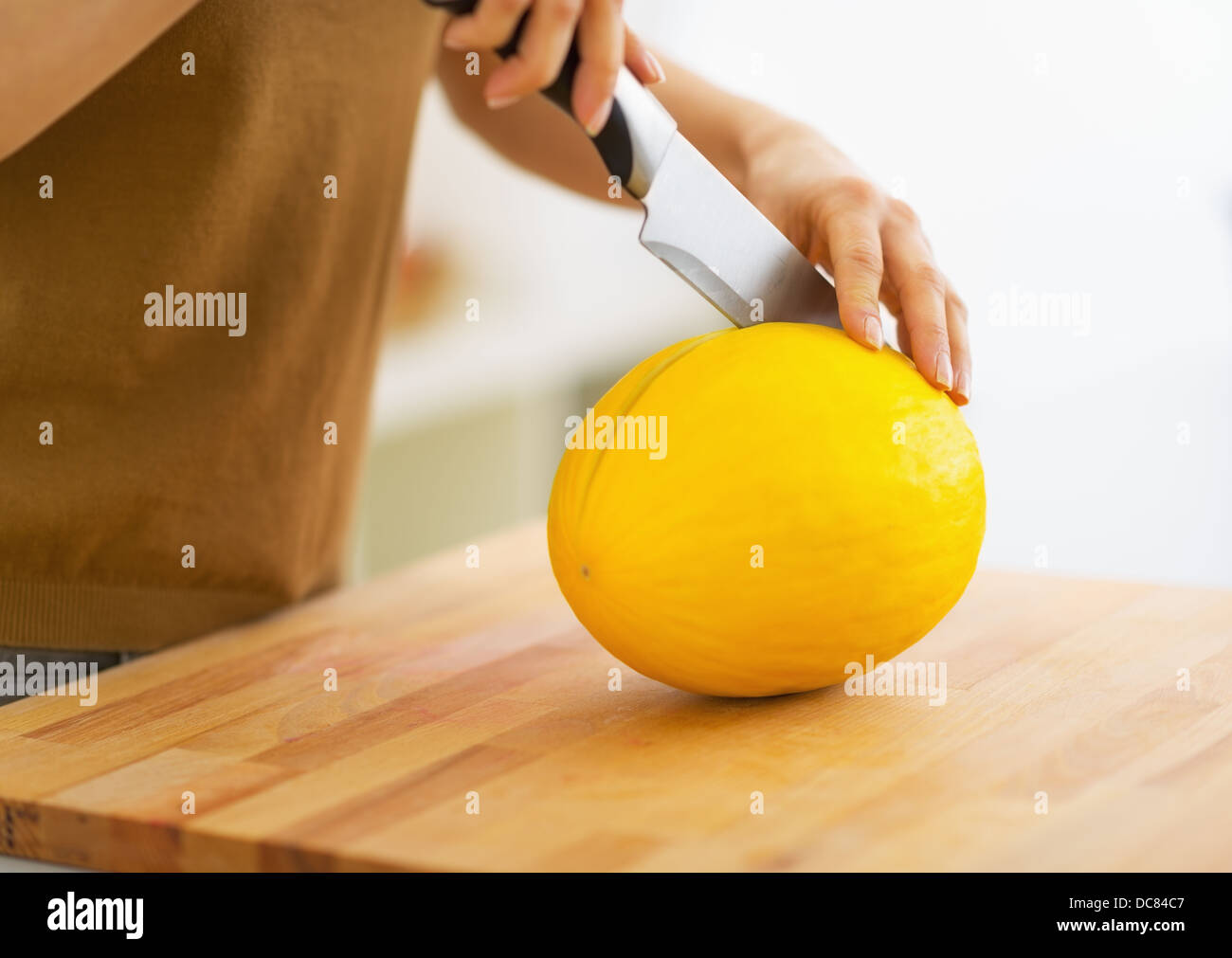 Closeup on woman cutting melon Stock Photo - Alamy