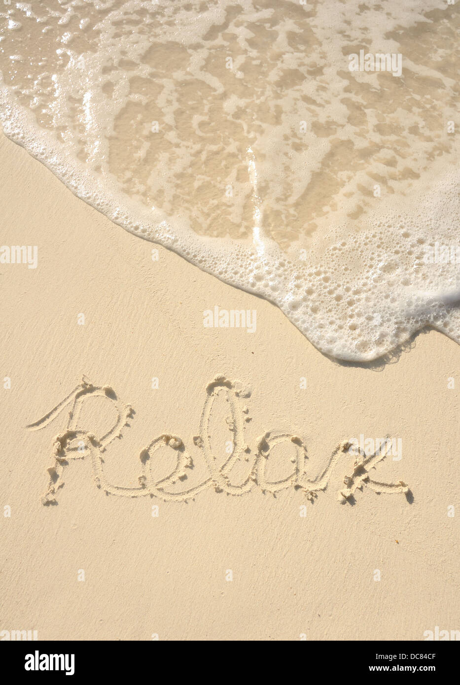 The Word Relax Written in the Sand on a Beach Stock Photo - Alamy