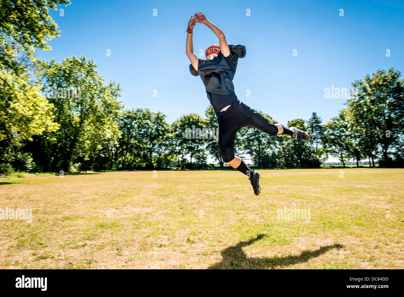 Action high jumping football hi-res stock photography and images - Alamy