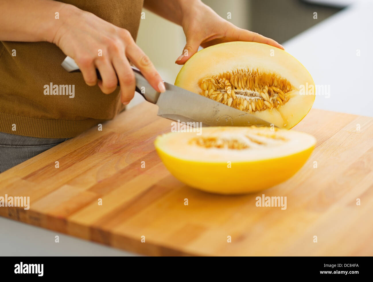 Closeup on woman cutting melon Stock Photo - Alamy
