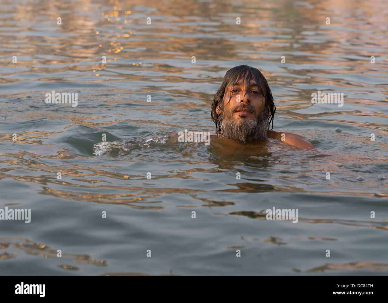 Portrait of man swimming / bathing in the Ganges River ( Varanasi Stock ...