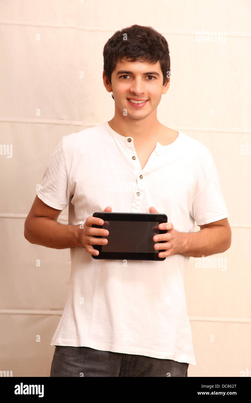 A young, latin man with a Tablet PC, face in focus Stock Photo - Alamy