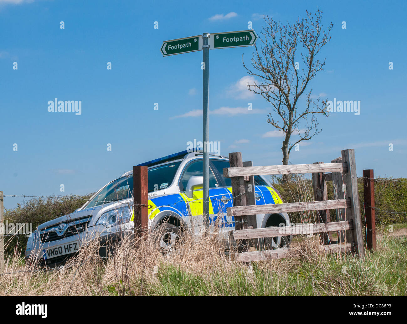 4x4 police car parked by a footpath in rural environment investigating ...