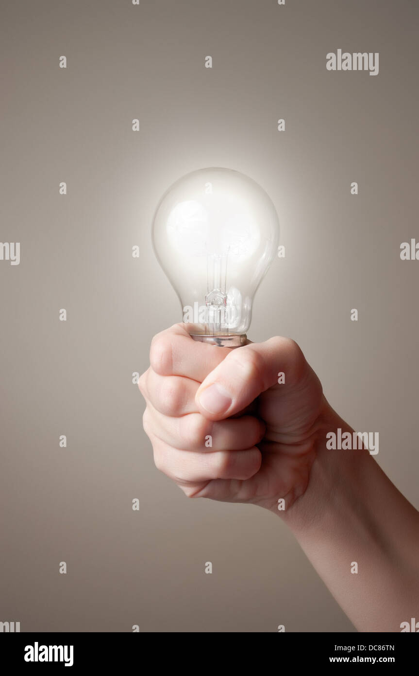 Hand with light bulb Stock Photo - Alamy