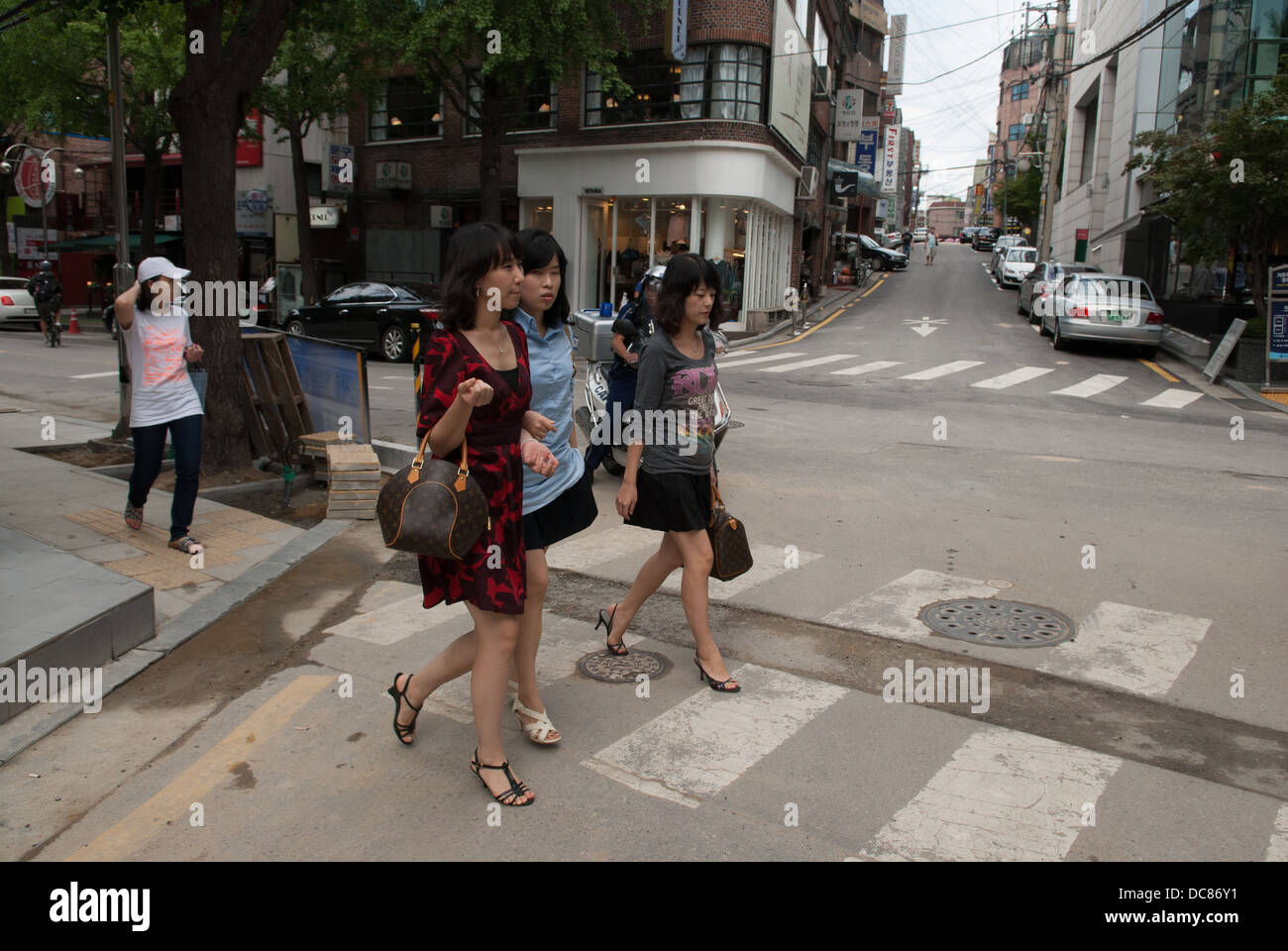 Young women on a shopping spree in trendy Sinsa-dong, Seoul, South ...