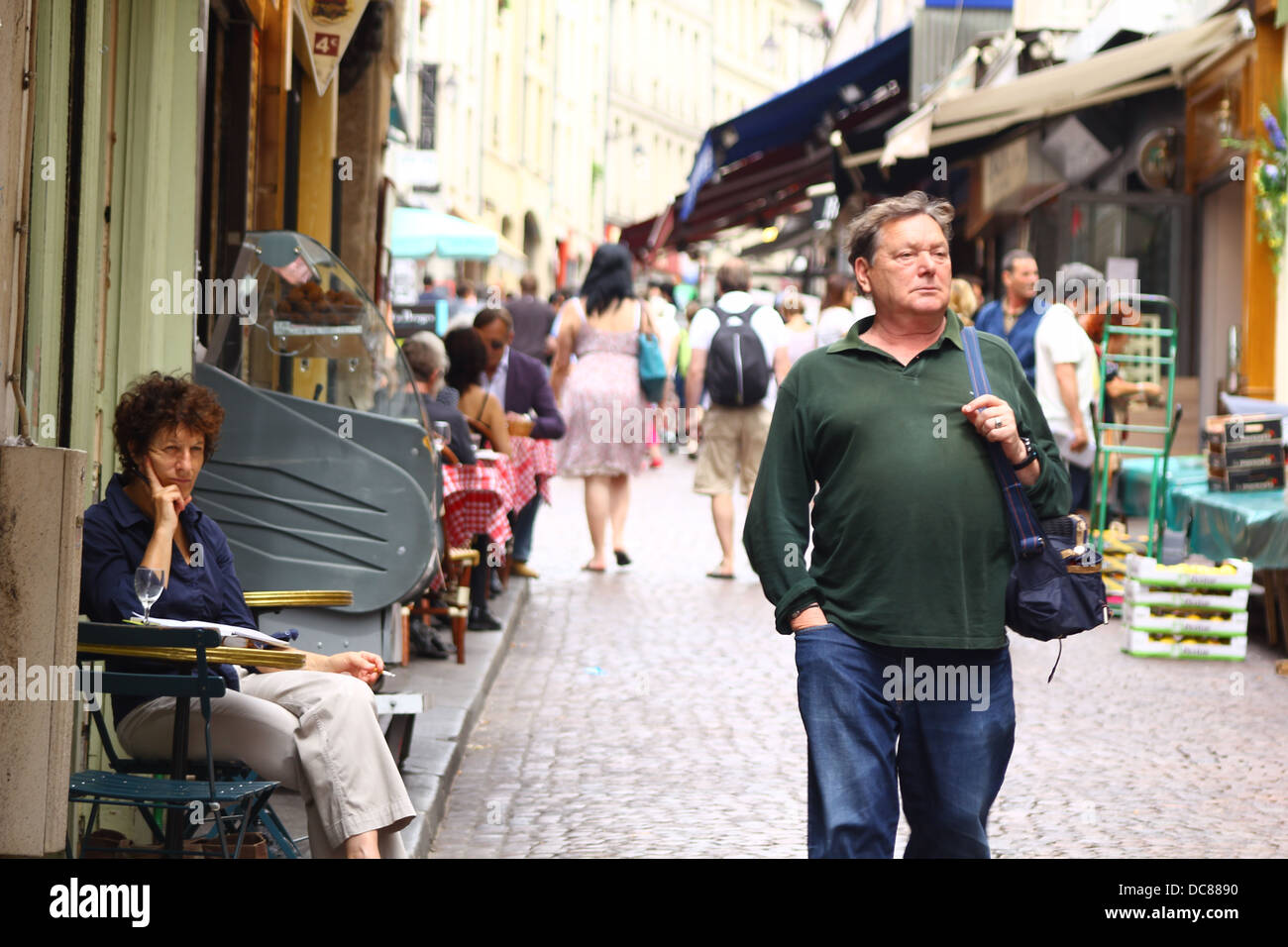 Mouffetard street in Paris - elder lady watching passing man from the ...