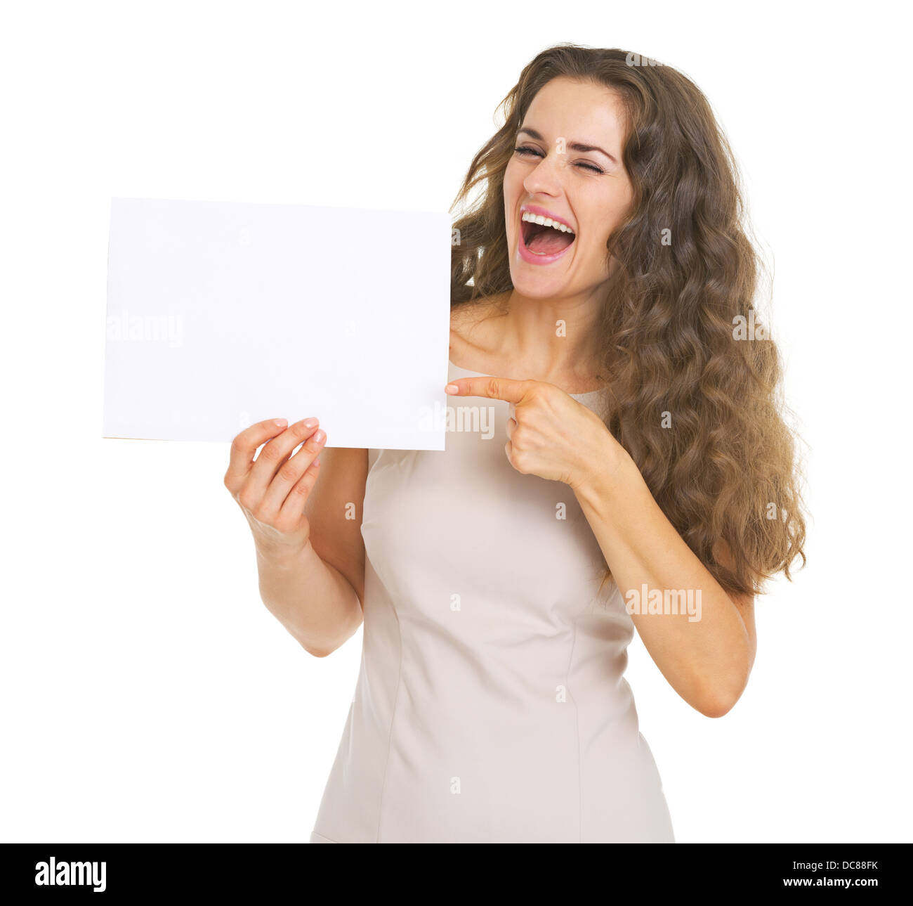 Smiling young woman pointing on blank paper sheet Stock Photo - Alamy