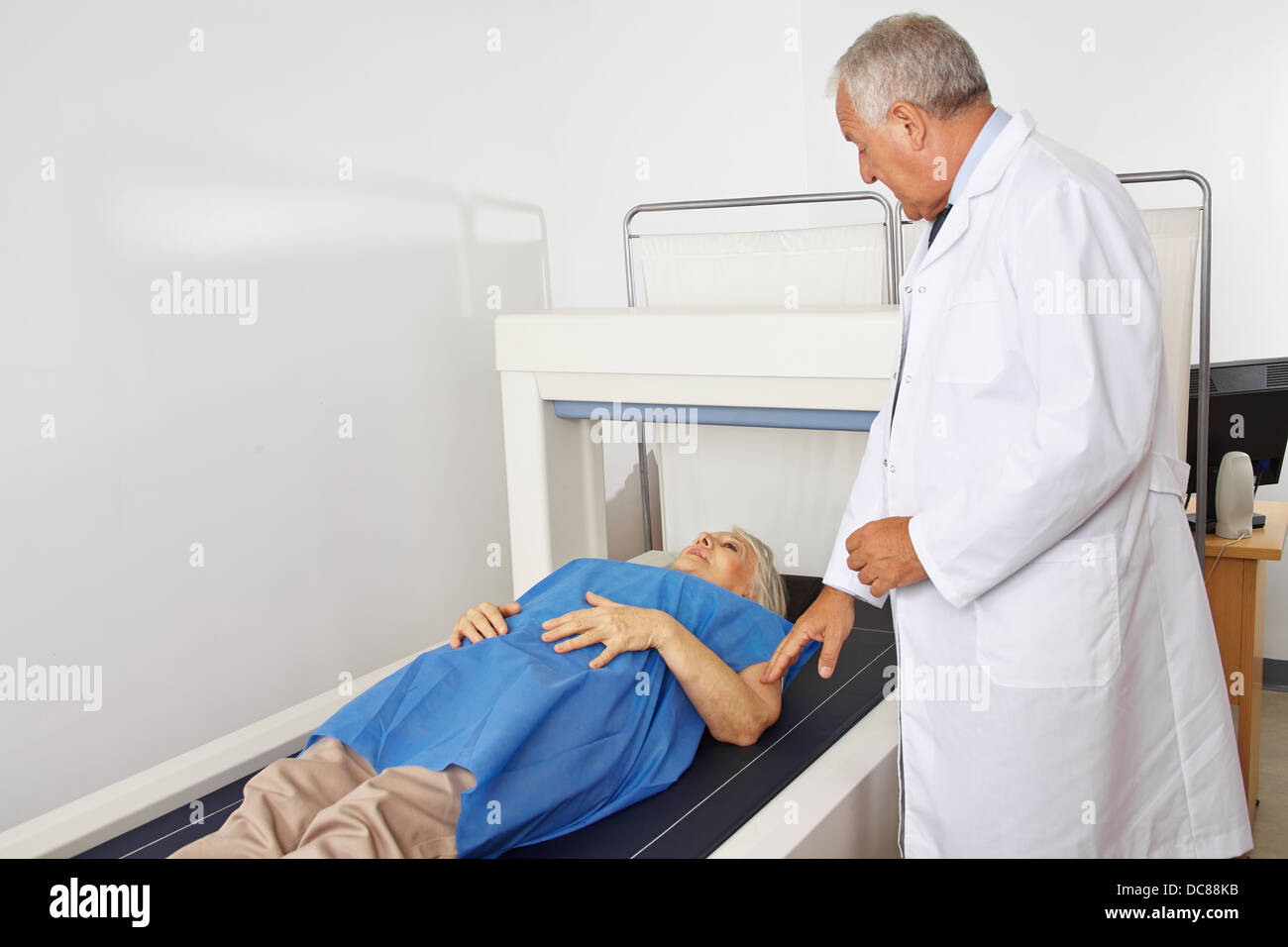 Doctor performing osteodensitometry in radiology to senior patient ...