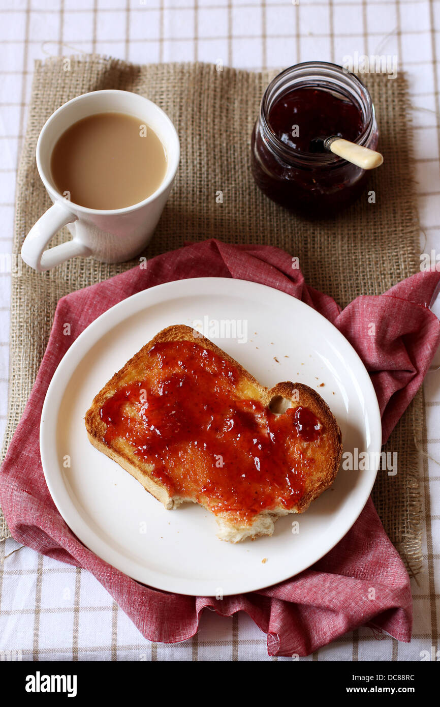 Toast with strawberry jam Stock Photo - Alamy