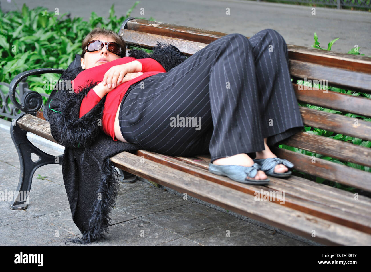 Woman sleeping on a bench in a park, Odessa, Ukraine Stock Photo - Alamy
