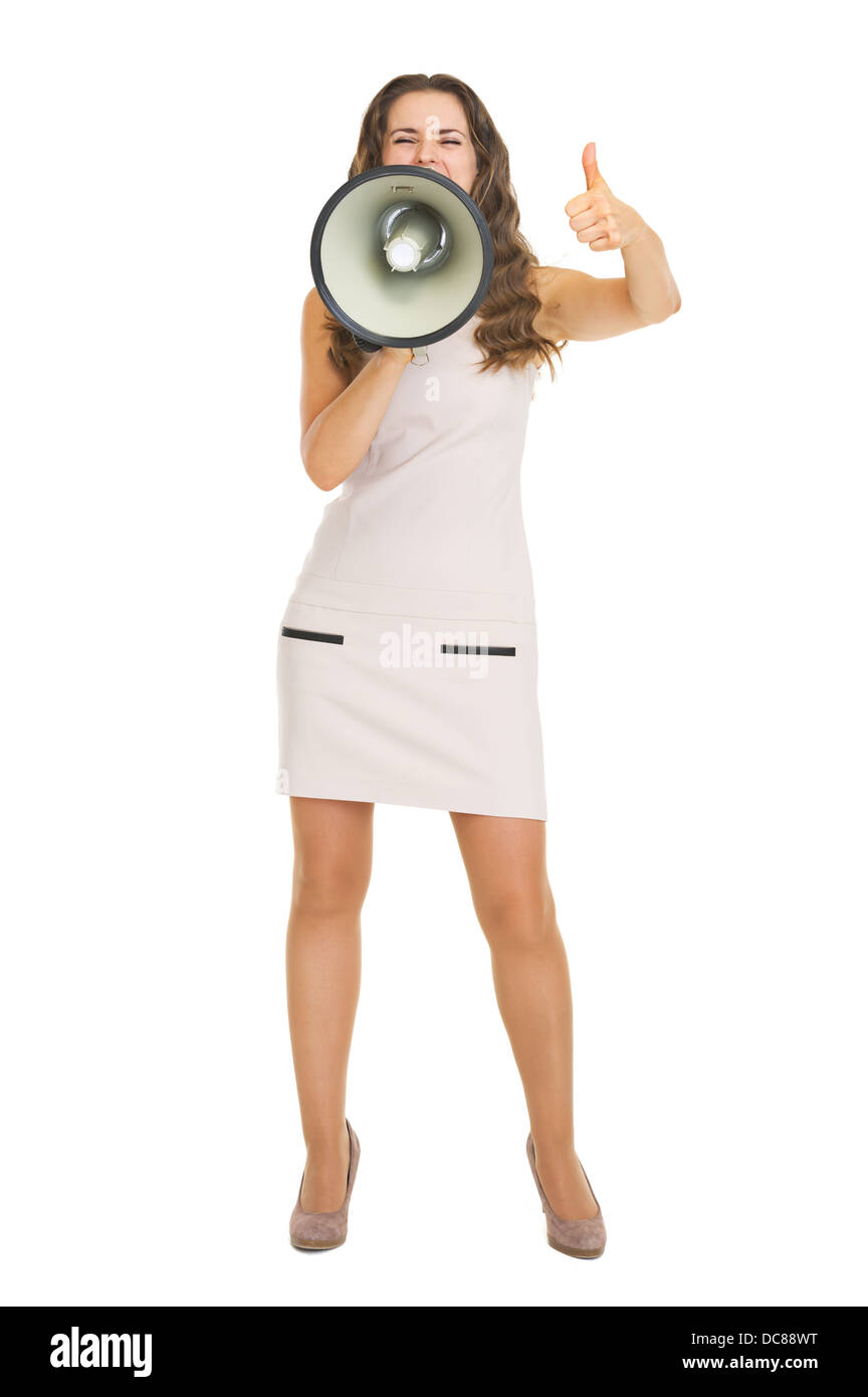 Full length portrait of young woman shouting through megaphone and ...