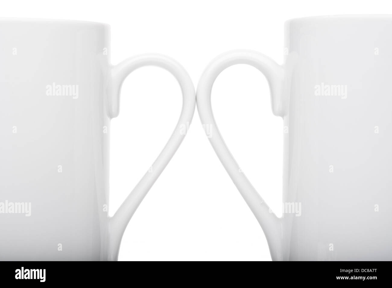 White cup handles touching. cutout Stock Photo - Alamy