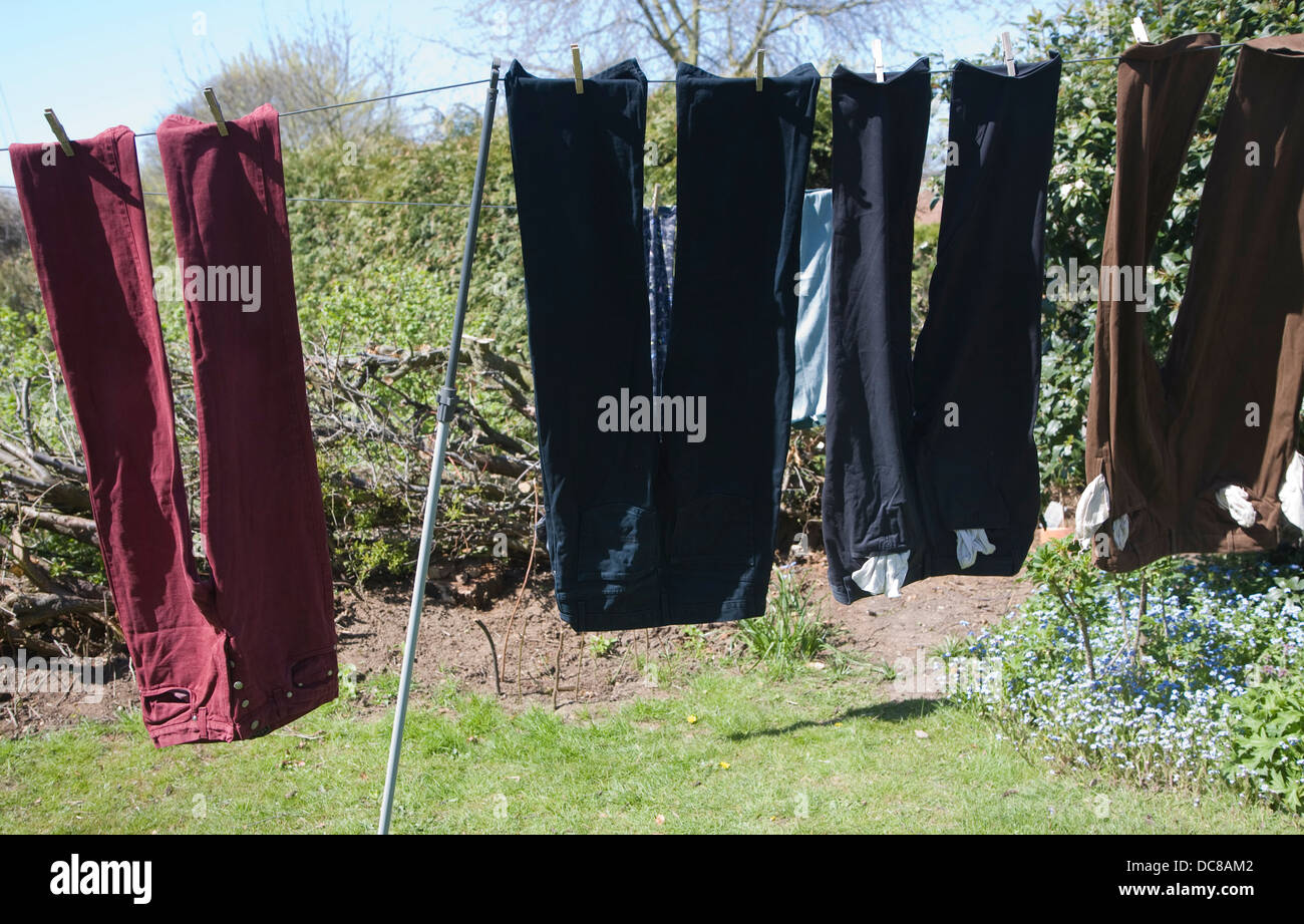Washing line trousers drying in a garden on a sunny day Stock Photo - Alamy