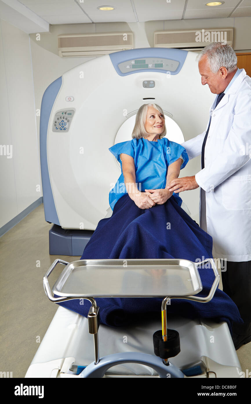 Radiologist talking to a senior woman patient at MRI therapy Stock ...