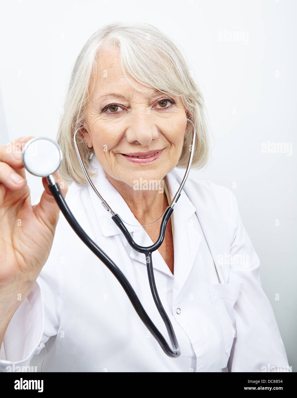 Elderly doctor with stethoscope in her hand Stock Photo - Alamy