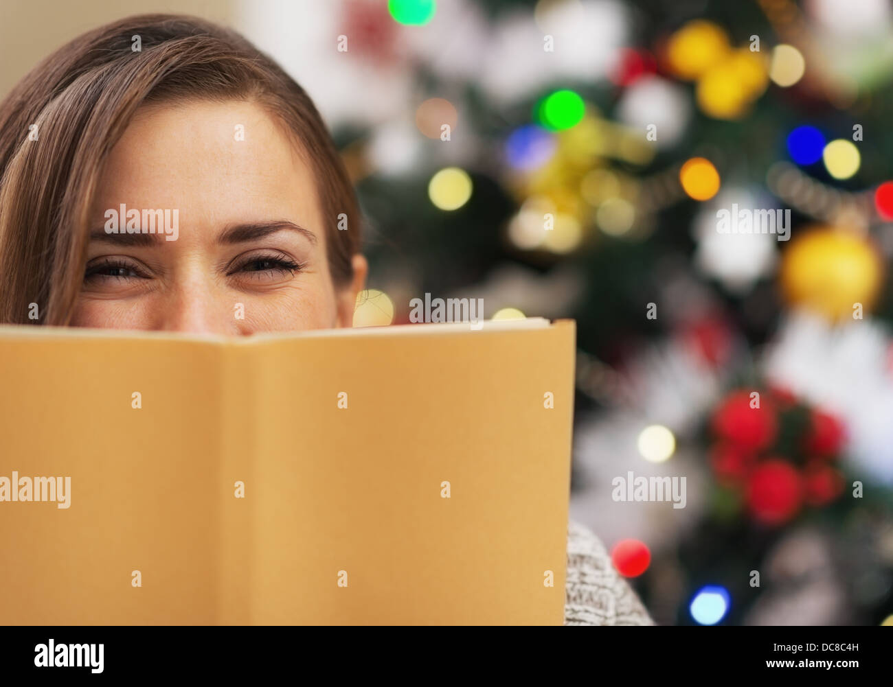 Woman hiding book holiday hi-res stock photography and images - Alamy