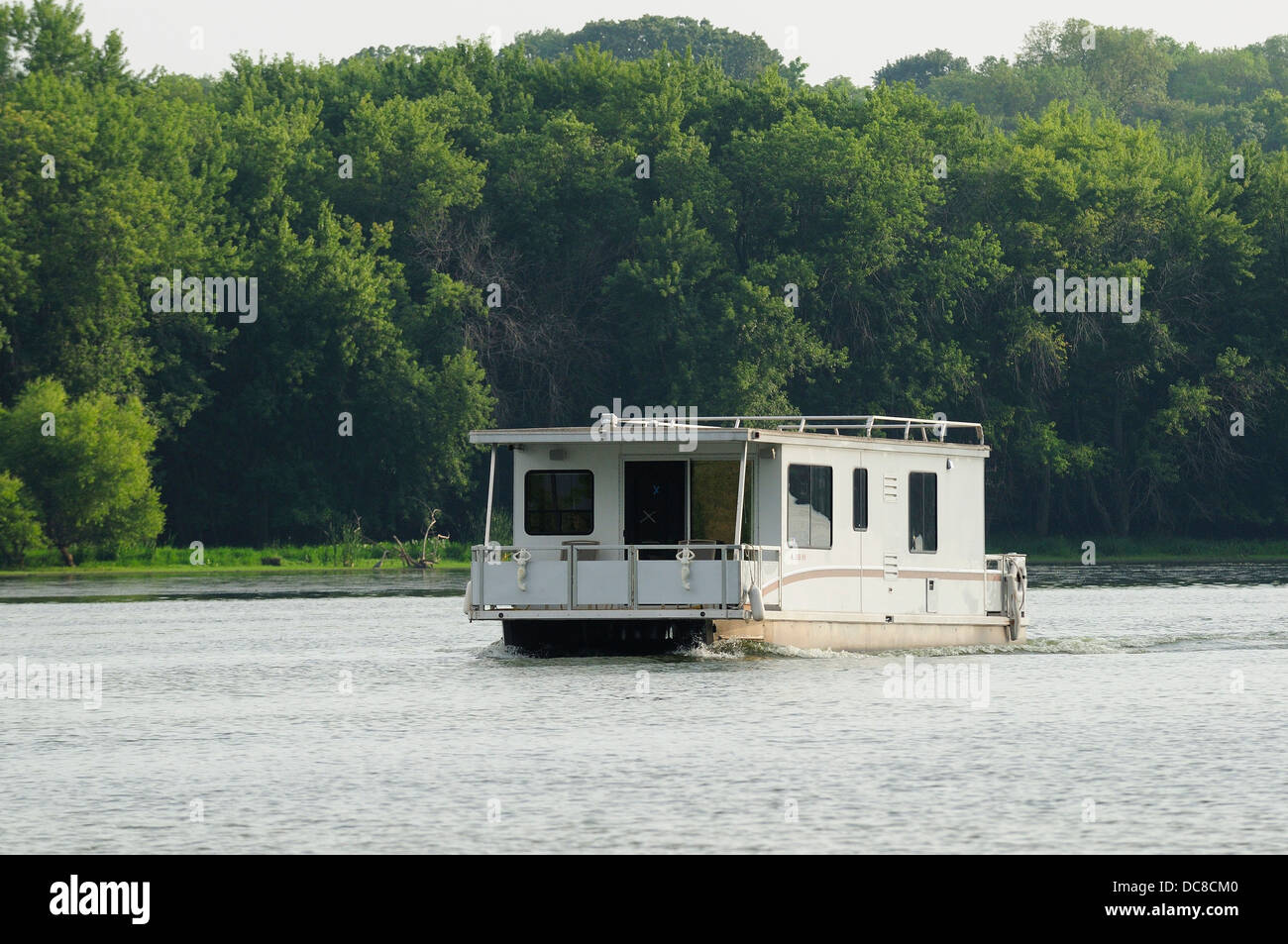 House boat cruising up a river Stock Photo - Alamy