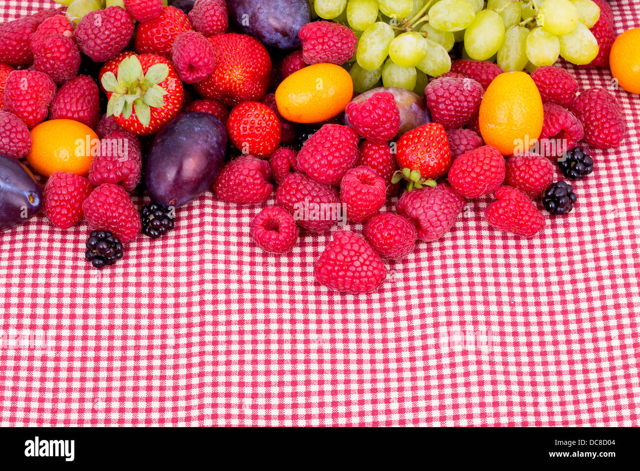 tasty summer fruits on a red and white gingham tablecloth. Strawberry ...