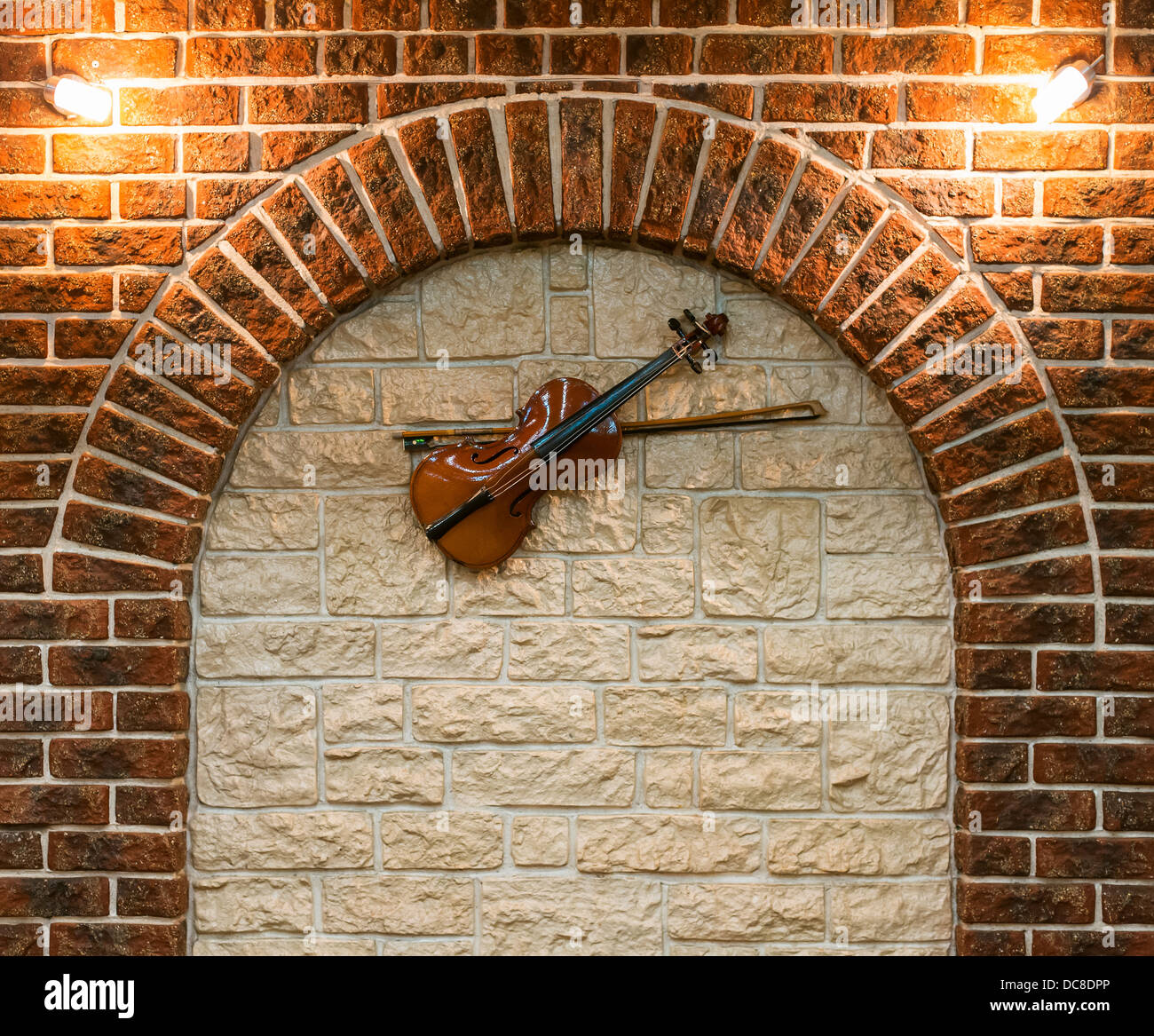 Element of the interior stone arch with a violin on a wall Stock Photo ...