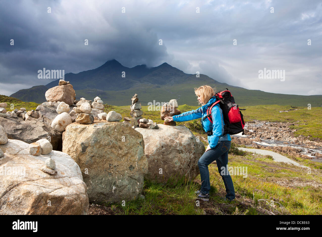 Walker adding taking stones to memorial Cairns; The Scottish Cullin ...