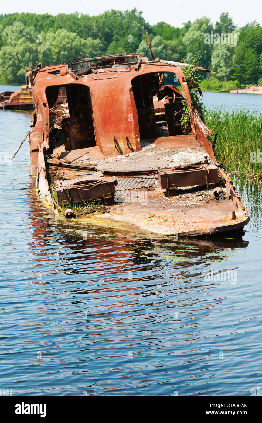 Wrecked abandoned ship on a river after nuclear disaster in Chernobyl ...