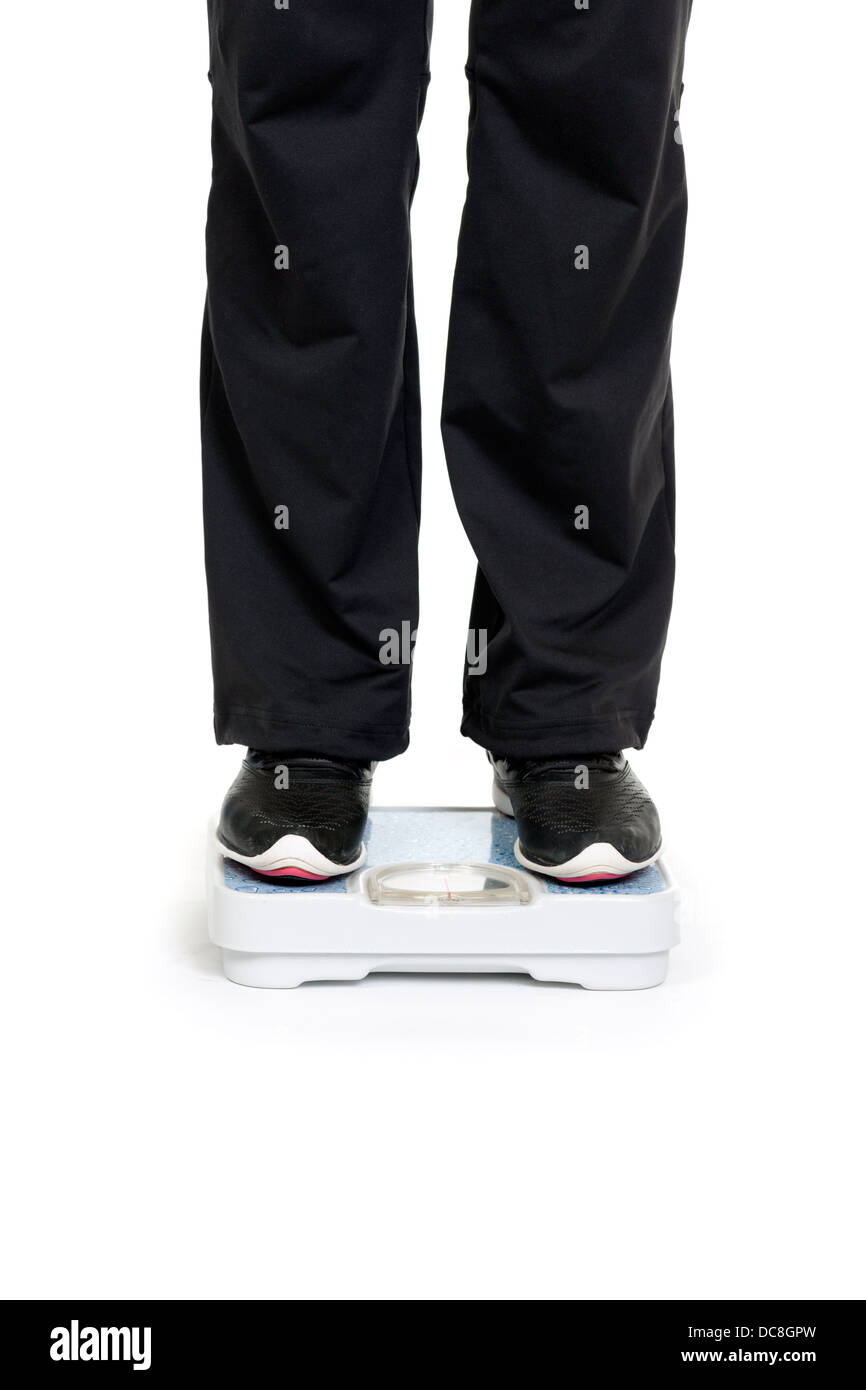 Feet on scales isolated on white background Stock Photo - Alamy
