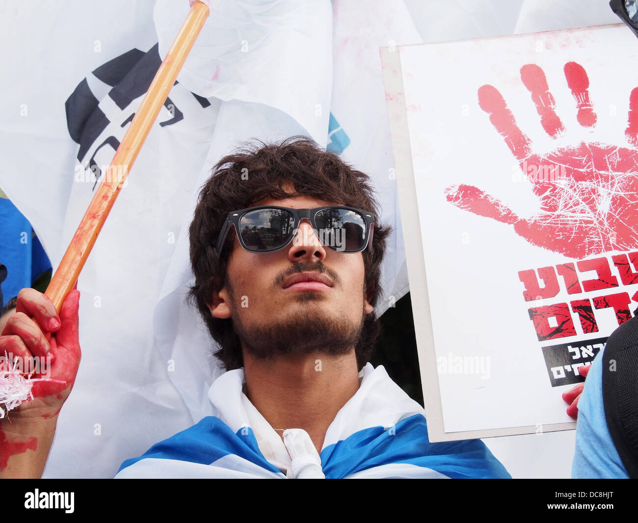 Tel Aviv, Israel. 12th August 2013. Protesters with red stained hands ...