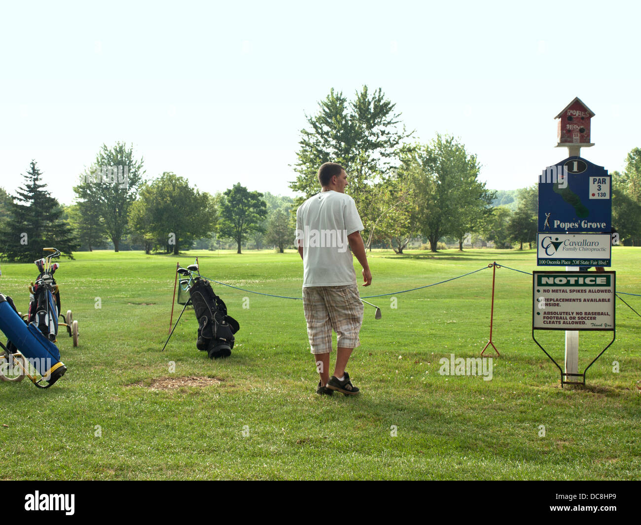 teenage boy getting ready to play a game of golf Stock Photo - Alamy