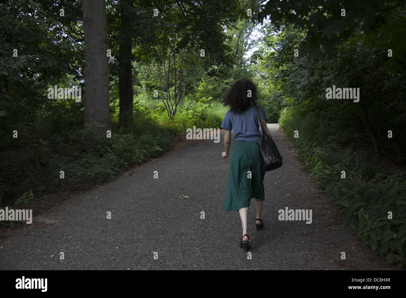 Woman walking path rear view hi-res stock photography and images - Alamy
