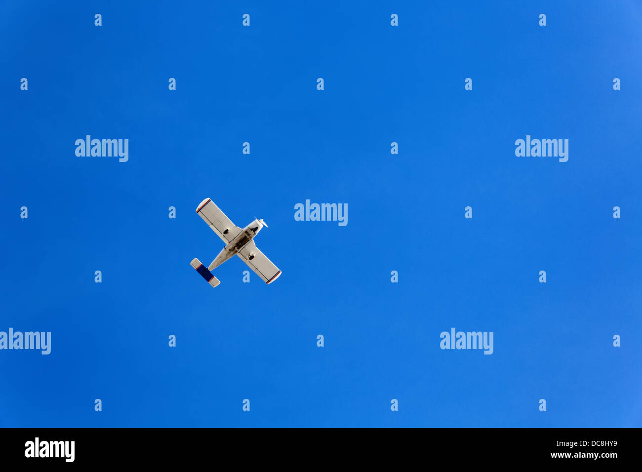 Small flying aircraft in a blue sky Stock Photo - Alamy