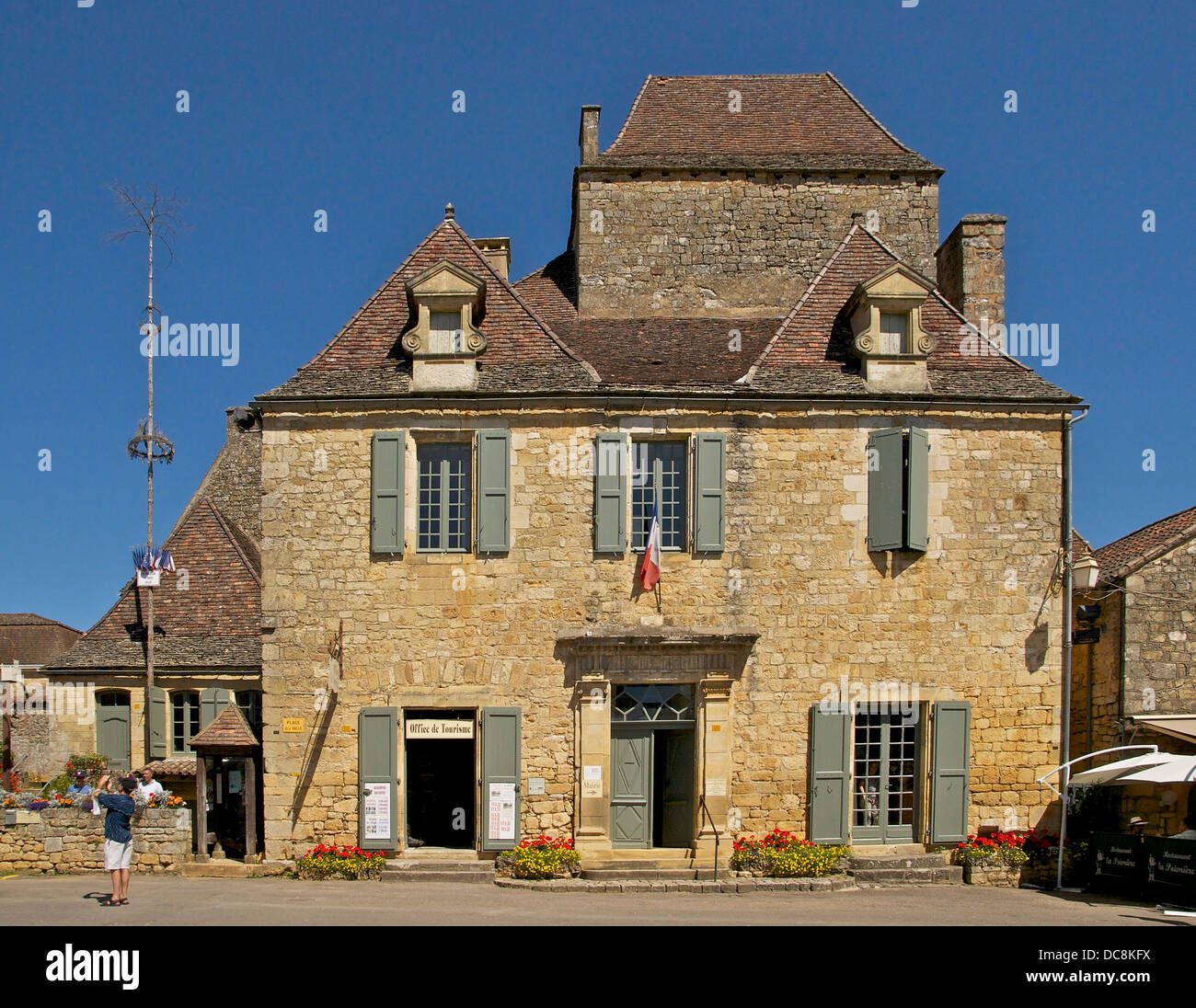 Town hall of Domme, Dordogne, France. left, a traditional maypole Stock ...