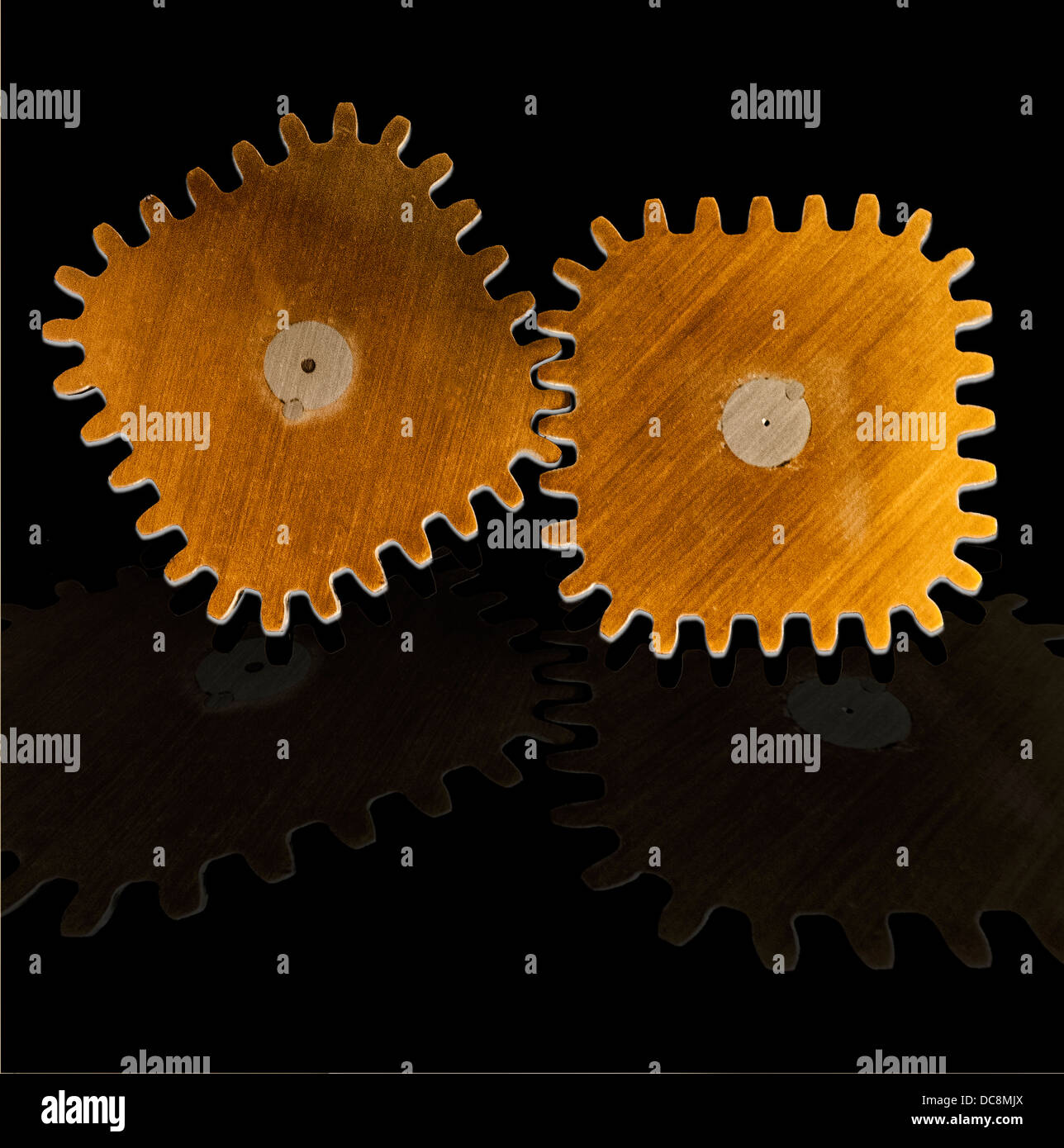 Square brass gears on a black background Stock Photo - Alamy