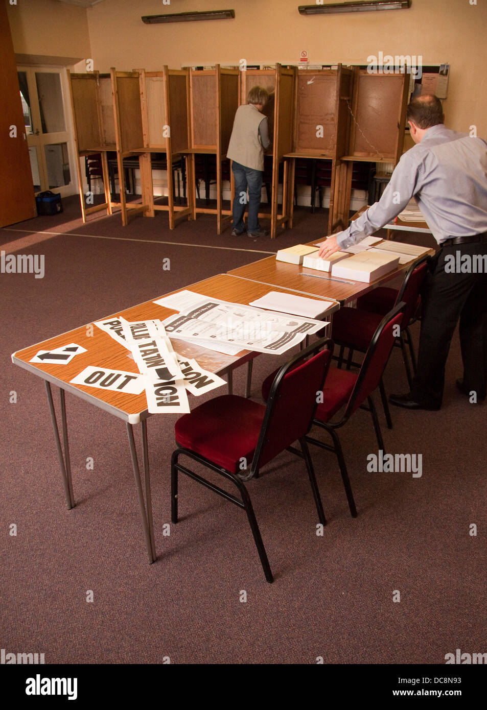 Two poll officials prepare a polling station in a church hall Stock ...