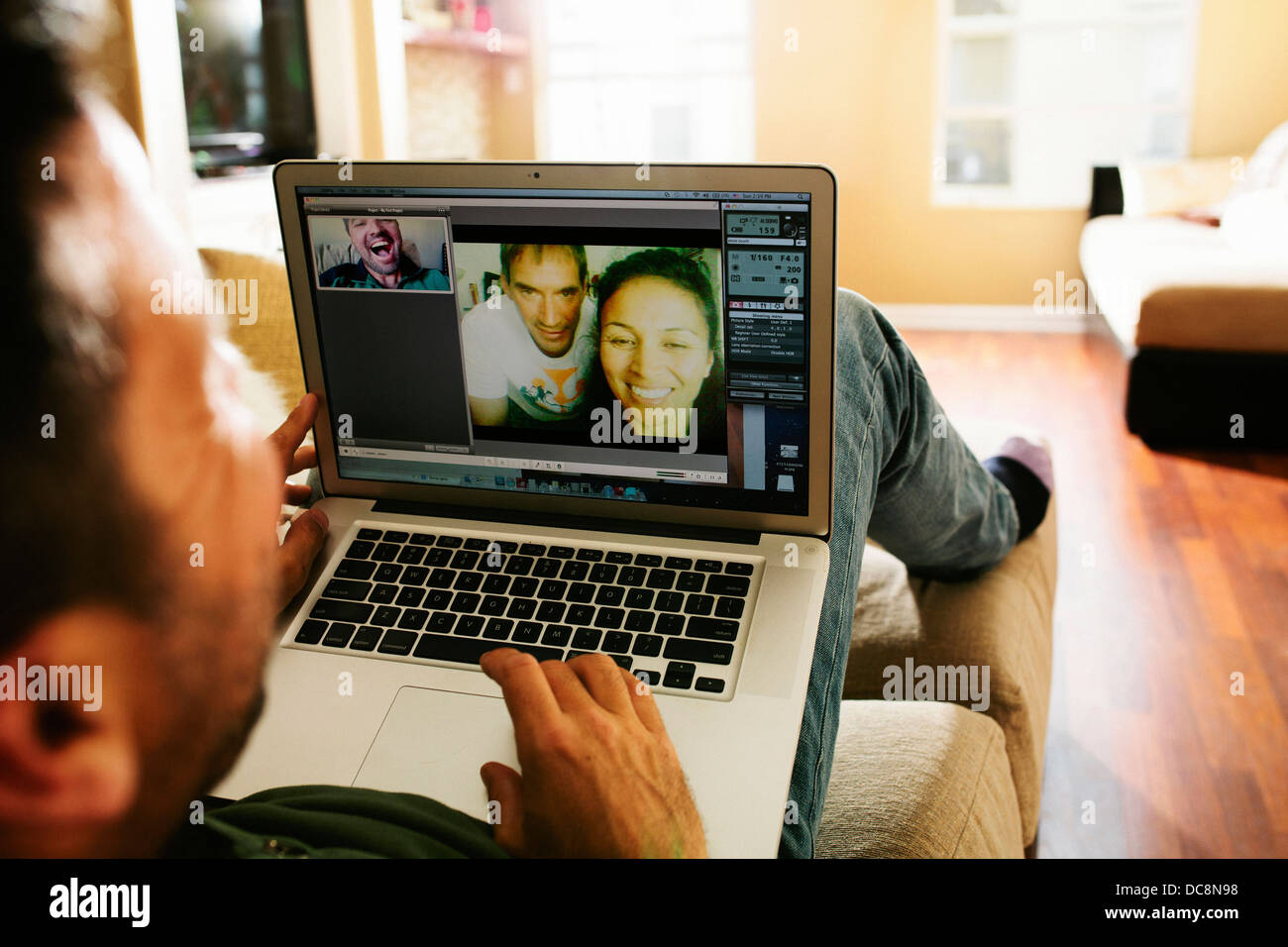 Man on a video call with his friends Stock Photo - Alamy